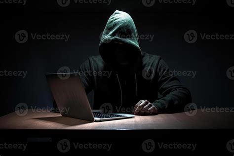 Hacker Wearing Black Hoodie Using Laptop Computer While Working On Dark Background 22813407