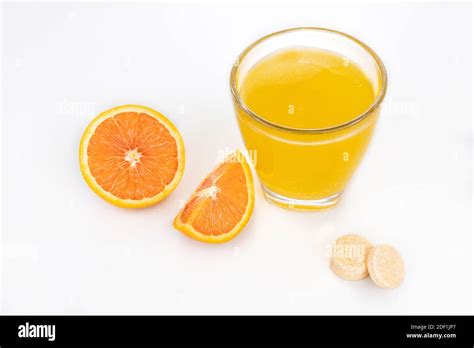 Orange Flavored Vitamin C Effervescent Tablet Dissolve In Glass Of