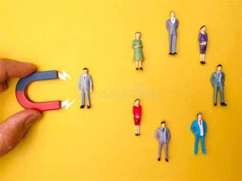 Array Of Figurines Arranged In A Pattern With A Magnet And An Arrow