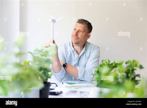 Business Portrait Of Environmental Engineer Sitting At His Work Table