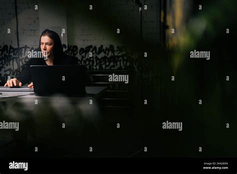Wide Shot Of Serious Young Hacker Man In Sweatshirt Typing Keyboard