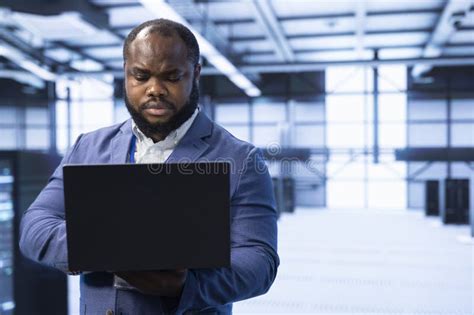 Data Center Worker Doing Hardware Installation Using Notebook Stock