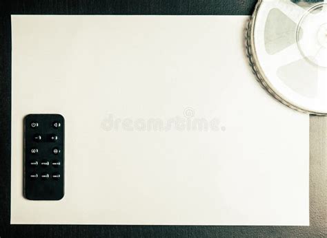 Vintage Film Roll With Remote Controller On Blank Paper Stock Image