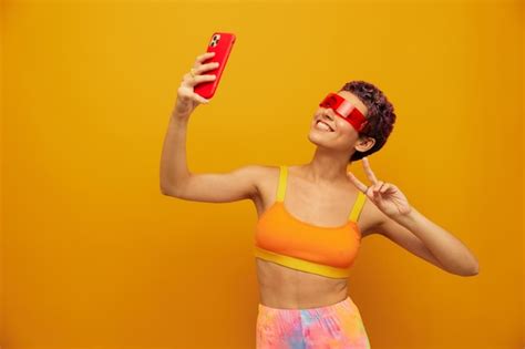 Woman Blogger Smiling In Unusual Millennial Glasses Taking Selfies On Her Phone In Sportswear