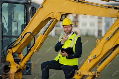Premium Photo Architect At A Construction Site Architect Man In Helmet And Suit At Modern Home