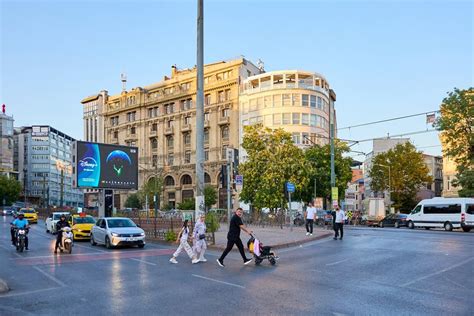 Urban Street Scene With Diverse Adults And Traffic In City Intersection
