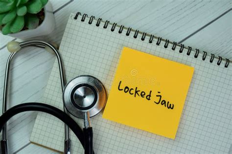 Concept Of Locked Jaw Write On Sticky Notes Isolated On Wooden Table
