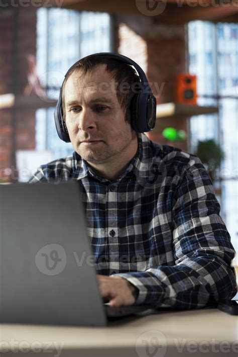 Worker Listening Music Analyzing Data On Laptop At Desk Compiling