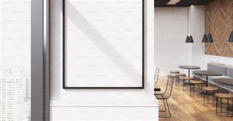 카페 벽에 세로 액자 포스터를 클로즈업한다 커다란 창문 흰색과 나무 벽 소파와 스툴이 있는 원형 테이블 3d 렌더링 모형