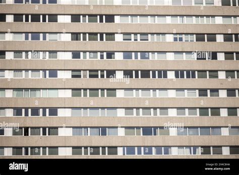 Facade With Granite Cladding And A Multitude Of Similar Windows Some With Curtains And Others