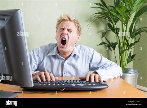 Tired Man Yawning When Working In Front Of Computer In Office Model