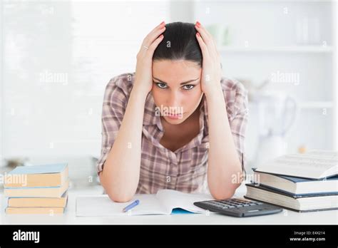Woman Holding Her Head In Her Hands Stock Photo Alamy