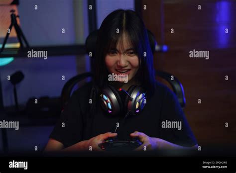 Female Cyber Hacker Gamer Using Controller Joystick To Playing Games On Computer With Serious