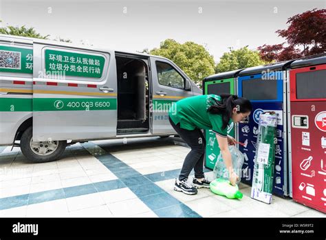A Chinese Worker Take The Garbage Away From The Garbage Sorting Bins In Hai An City Nantong