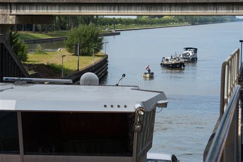 Pleasure Boats Waiting To Enter A Lock Behind An Large Inland Vessel