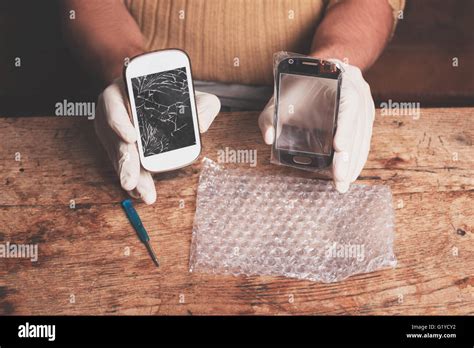 A Technician Is Fixing And Replacing The Broken Screen On A Smart Phone Stock Photo Alamy