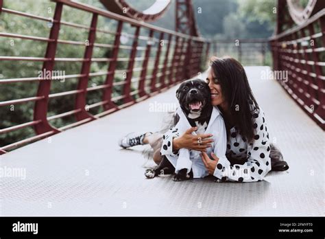 A Beautiful Young Woman In A Fluffy Skirt And A Polka Dot Blouse Sits
