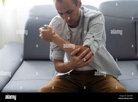 Man S Arm Touches A Painful Wrist Caused By Work Stock Photo Alamy