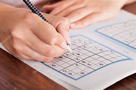 Woman Solving Sudoku Stock Photo AndreyPopov