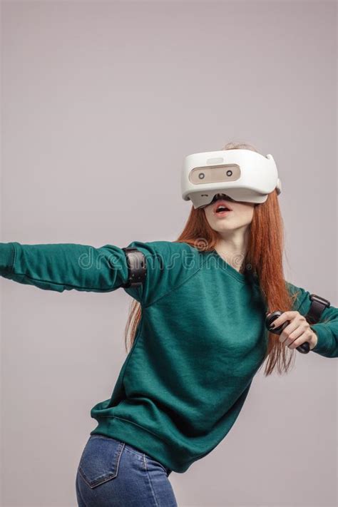 Confident Redhead Woman Wearing Virtual Reality Headset Aiming From The Bow Stock Photo Image