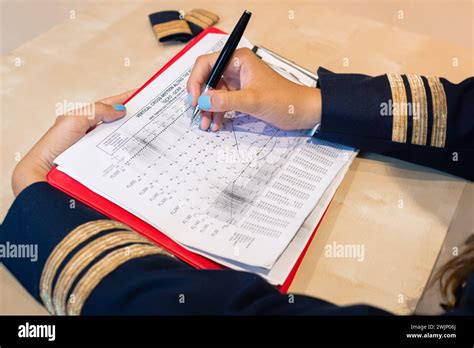 Unrecognizable Female Pilot Preparing Flight Documentation With A