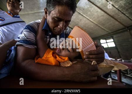 (151224) -- NORTH SUMATRA, Dec. 24, 2015 -- Paramedics perform a circumcision on a boy during a ...
