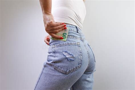 The Girl Slips A Hundred Euro Bill Into The Back Pocket Of Her Jeans A