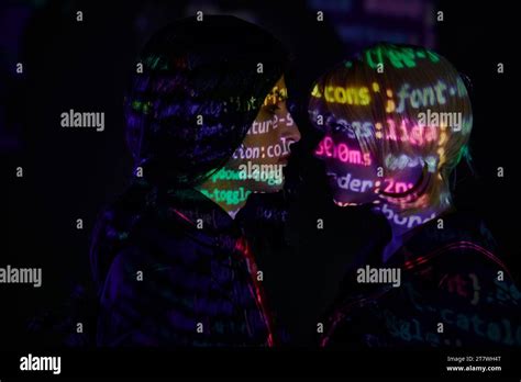 Side View Of Young Couple With Neon Programming Lettering On Dark Backdrop Anime Style Concept