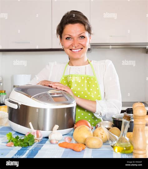 Smiling Housewife Cooking With New Multicooker In Home Interior Stock