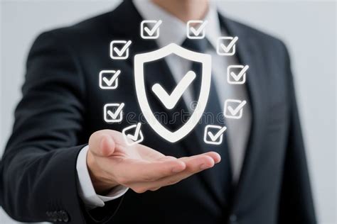 Businessman S Hand Holding A Digital Shield Icon Representing Security