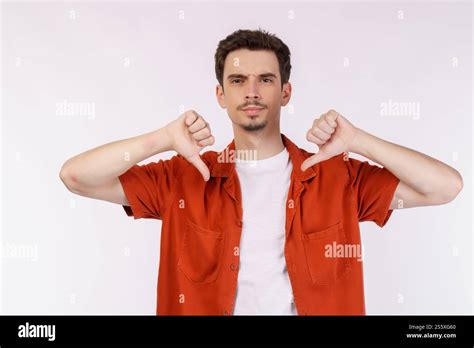 Portrait Of Young Man Shows Sign Of Dislike Looks With Negative
