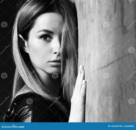 Young Beautiful Brunette Woman In Black Modern Leather Cloth Posing In