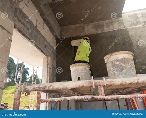 Plastering Work By Construction Workers Using The Cement Plaster