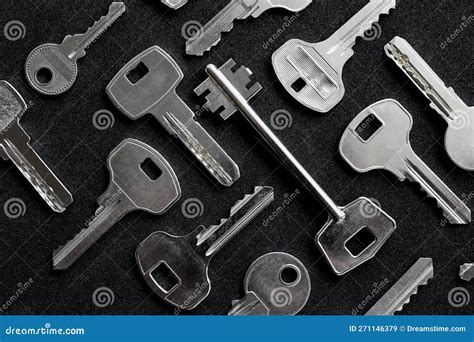 a pattern of different types of keys from locks laid out on black