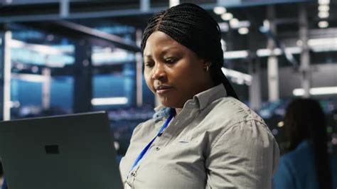 cheerful data center employee using node tree software to analyze