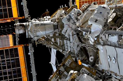 Spacewalking Astronauts Install Array Mount Outside Space Station Space