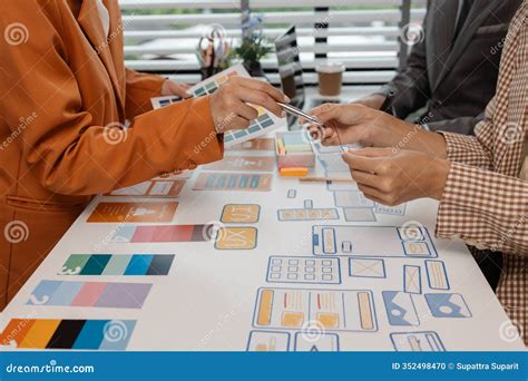 Ux Developer And Ui Designer Presenting Mobile App Interface Design On Whiteboard In Meeting At