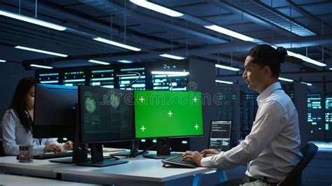 Engineer In Server Hub Using Green Screen Pc To Stop Hacker Stock Image