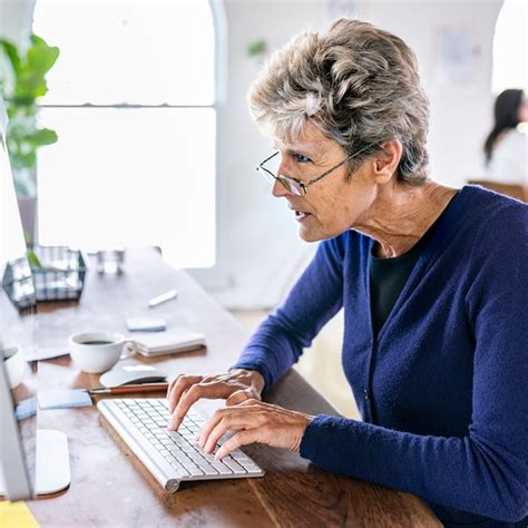 Premium Photo Senior Woman Typing On A Computer Keyboard