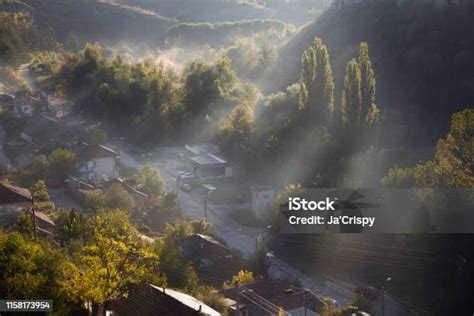 러브치 불가리아의 산 사이의 아름다운 안개 마을의 공중 보기 바위 산으로 둘러싸인 도시 지구의 안개 낀 일출 전망 나무 사이의 태양 광선 도시에 대한 스톡 사진 및 기타