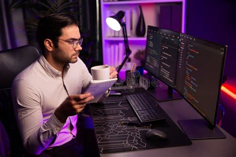 it working with drinking coffee coding on pc screen reading note