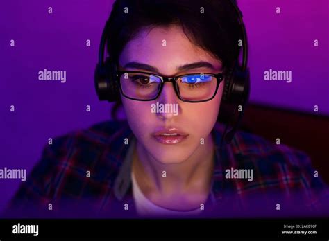 Female Programmer Working On Laptop Late At Night Room Illuminated By