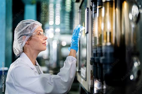 Scientist Woman Worker Checking And Monitoring The Control Panel On Machine System At The