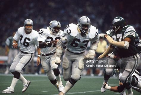 Arthur Whittington Of The Oakland Raiders Carries The Ball Led By