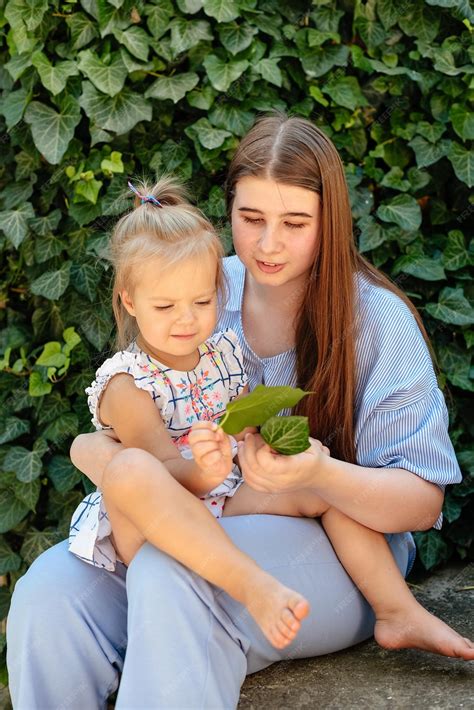 Premium Photo Joyful Older Sister Holding Younger Sister Playing And