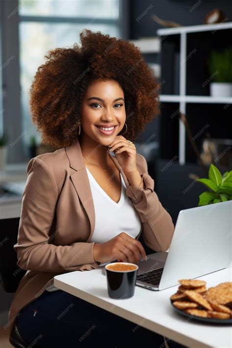 A Woman Sits At A Table With A Laptop And Coffee Premium Ai Generated