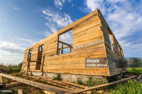 미완성된 생태 집 푸른 하늘 배경에 녹색 필드 공사중 참호는 시멘트와 조용한 지역에 미래 편안한 별장의 창 구멍으로 나무 벽 가득 개발에 대한 스톡 사진 및 기타 이미지