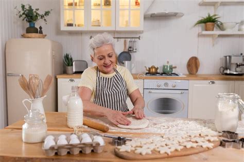 Happy Senior Woman Cooking In Kitchen Stylish Older Mature Gray Haired