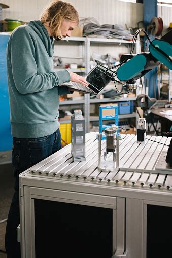 Photo Libre De Droit De Un Jeune Homme Développe Le Code Dun Bras Robotique Banque Dimages Et