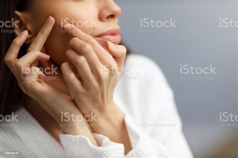 Attractive Upset Young Woman In White Bathrobe Examines Pimples On Her Face Close Up Problematic ...